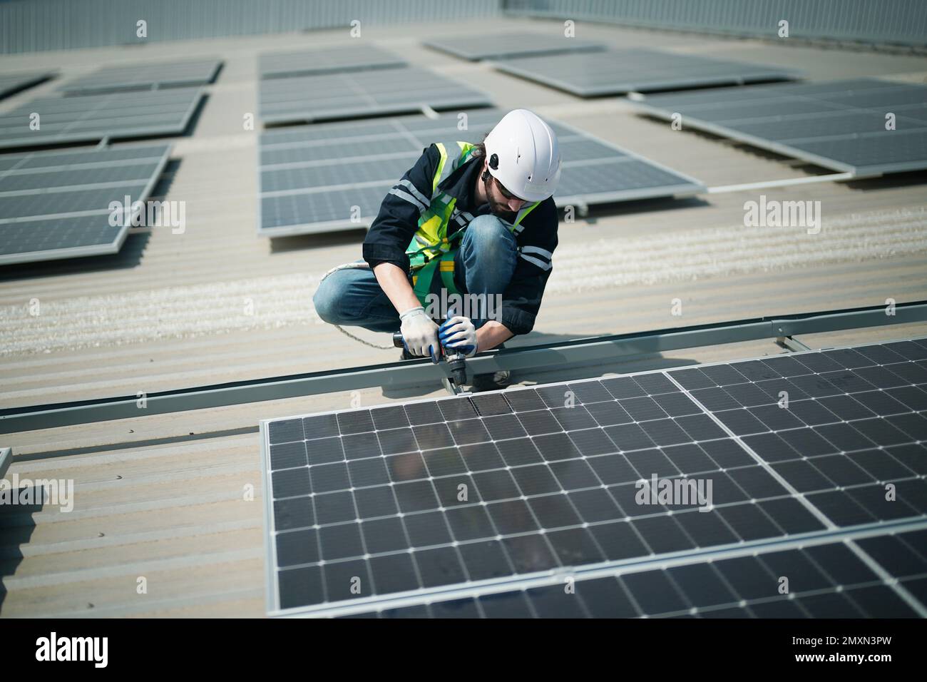 engineers installing solar panels on roof. Male engineers walking along ...