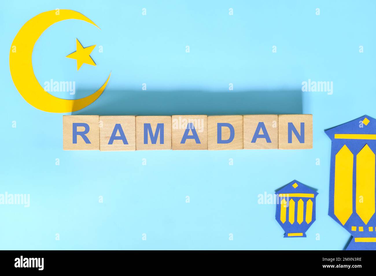 Crescent moon, star and lantern decoration with text on wooden blocks ...