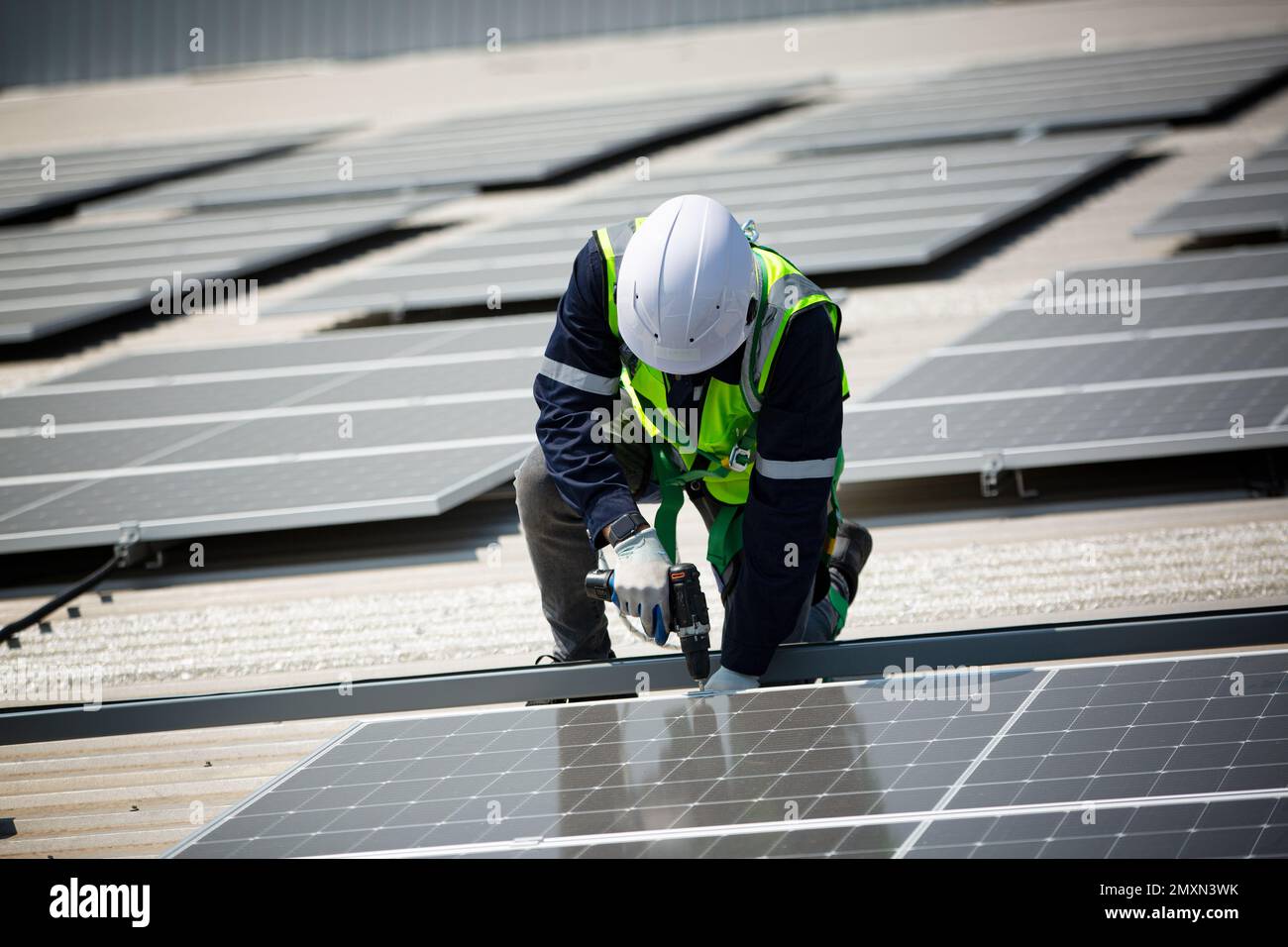 engineers installing solar panels on roof. Male engineers walking along ...