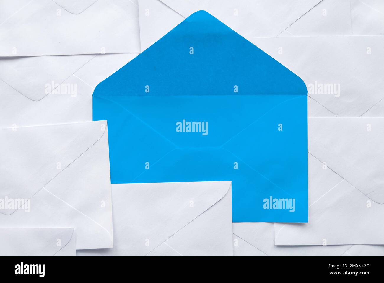 A stack of white envelopes with a blue open envelope for background ...