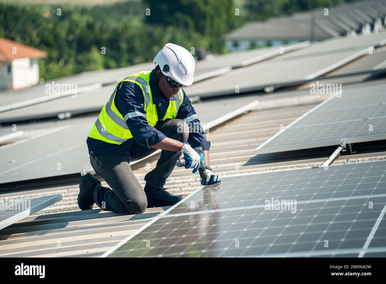 engineers installing solar panels on roof. Male engineers walking along ...