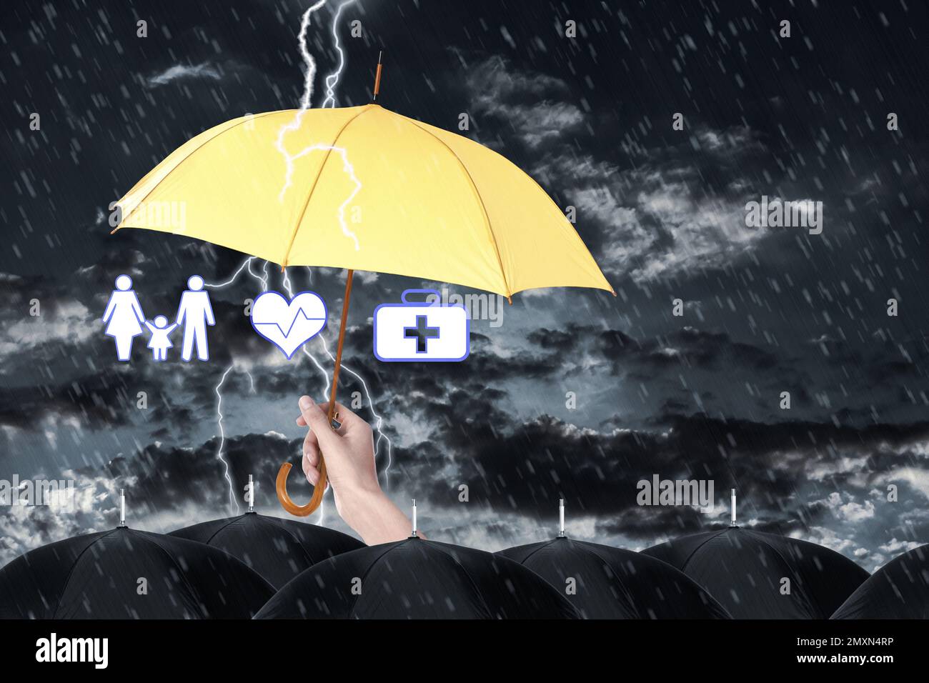 Insurance agent covering illustrations with yellow umbrella during ...
