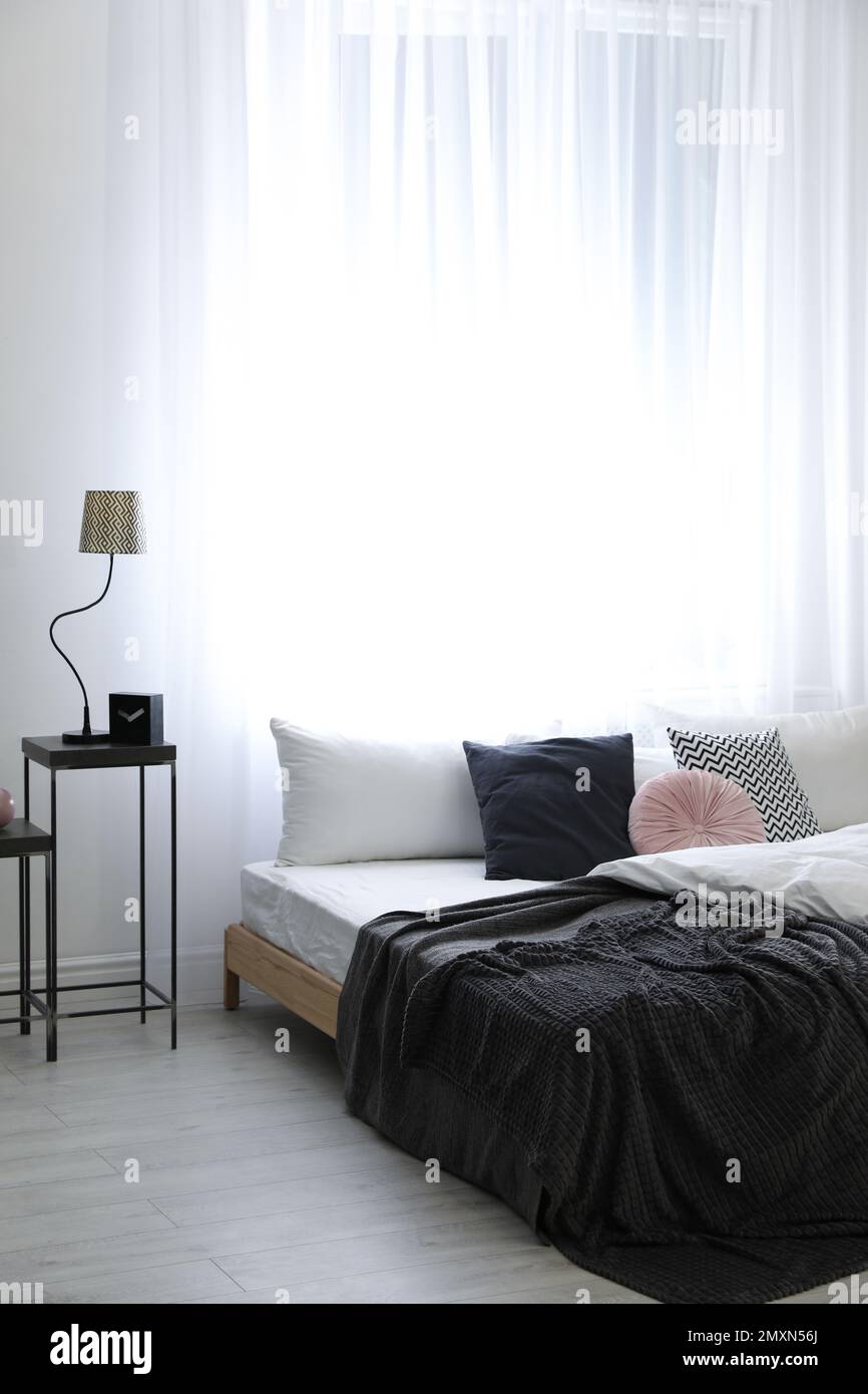 Stylish room interior with big comfortable bed Stock Photo - Alamy