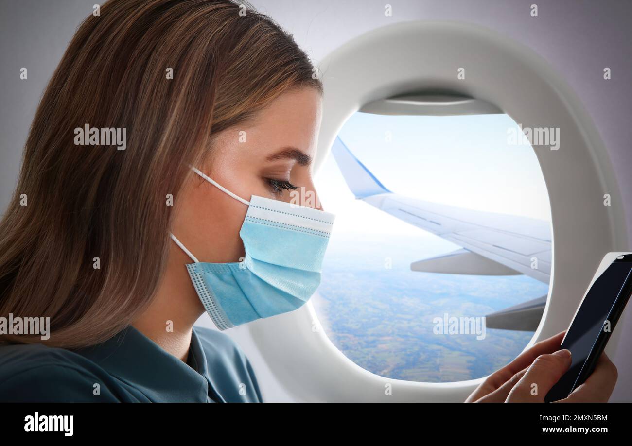 Traveling by airplane during coronavirus pandemic. Woman with face mask ...