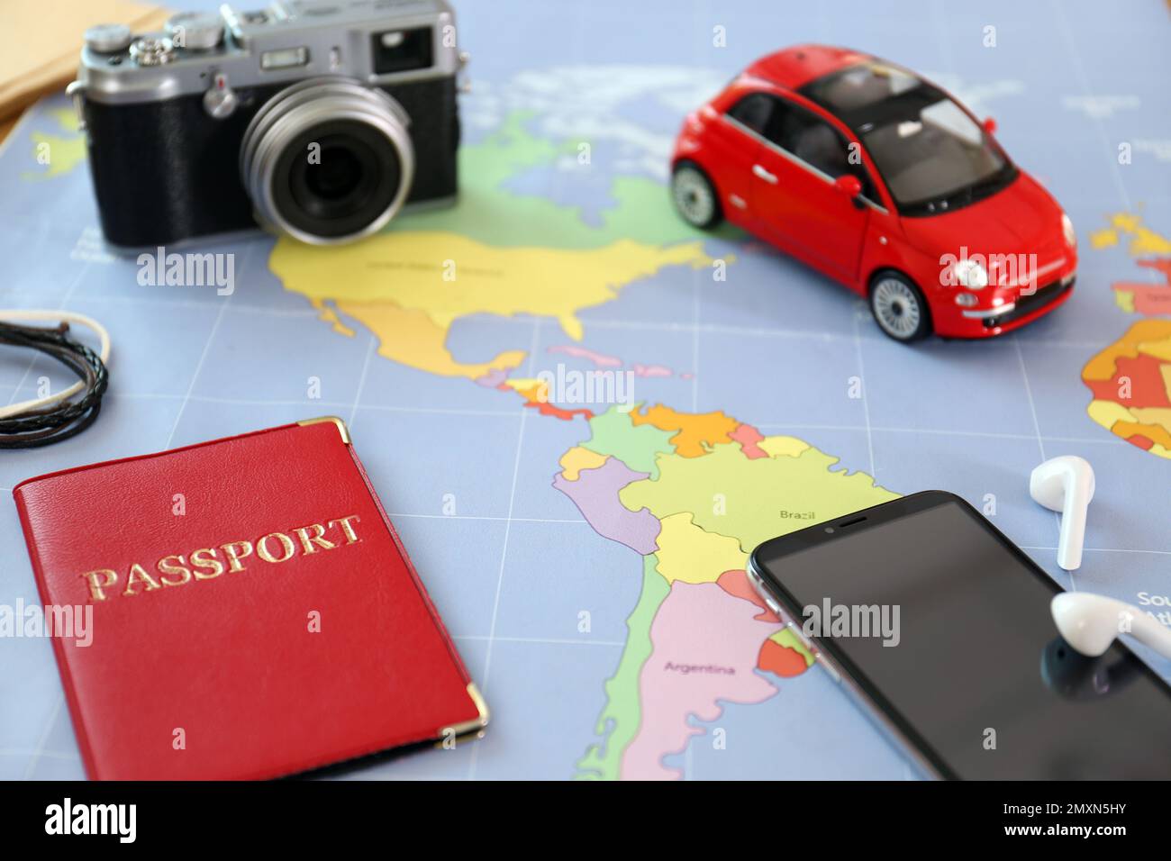 Composition with smartphone and different items on world map. Trip ...