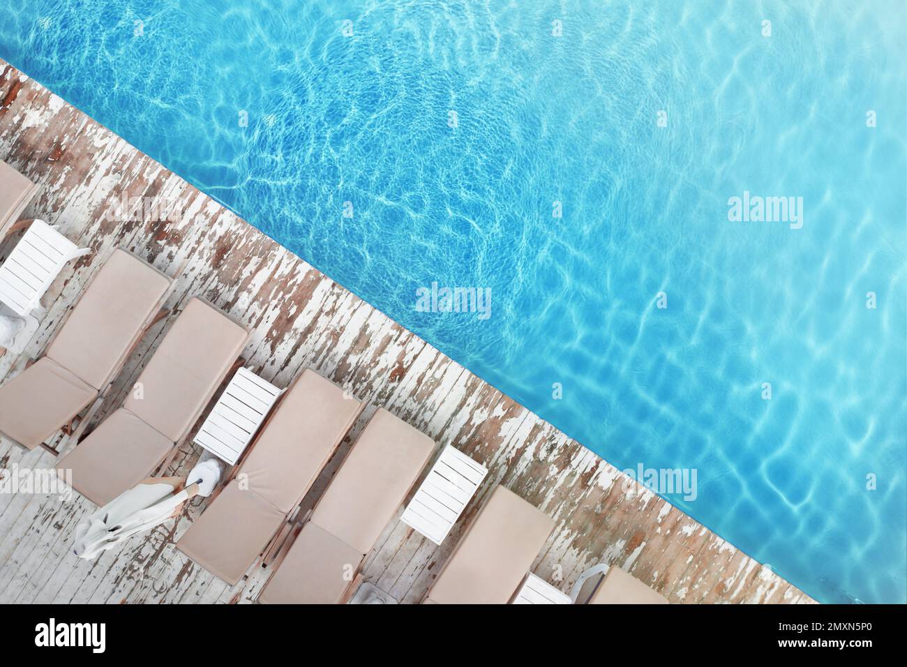 Sun lounge chairs near swimming pool, top view Stock Photo - Alamy