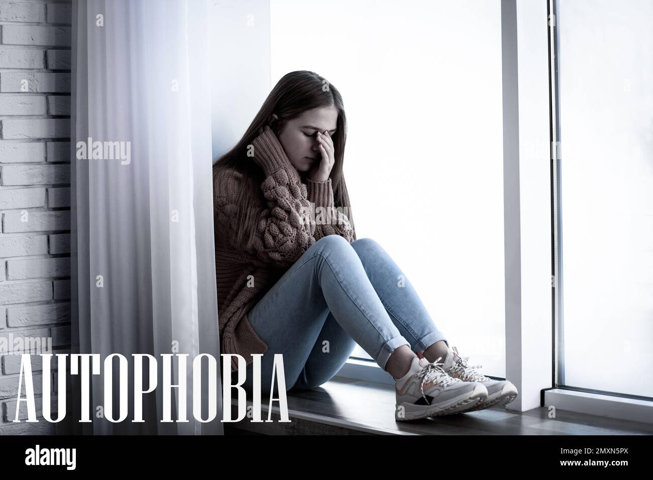 Depressed teenage girl sitting alone near window at home. Autophobia ...