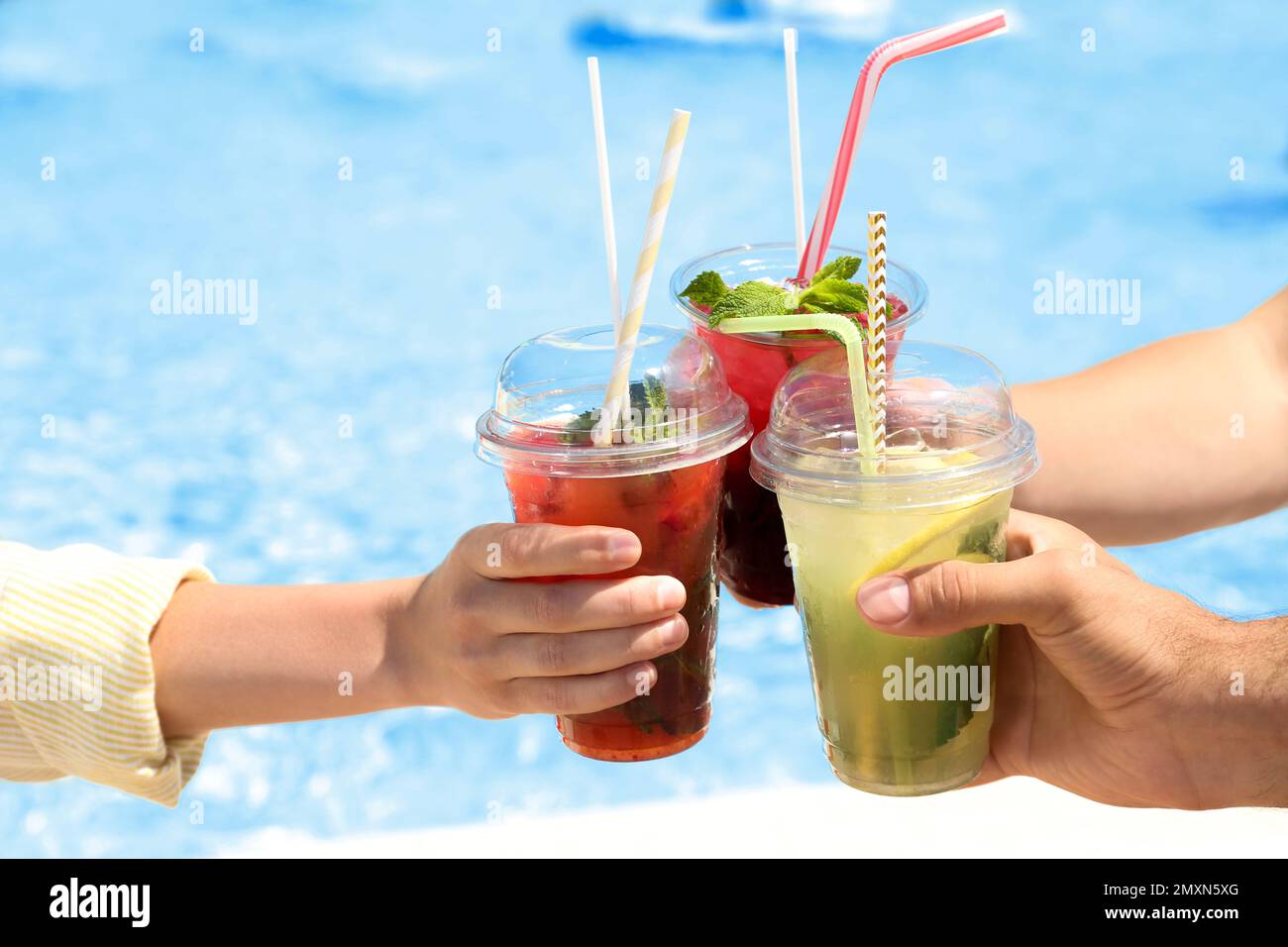 People with refreshing drinks in water park, closeup Stock Photo - Alamy