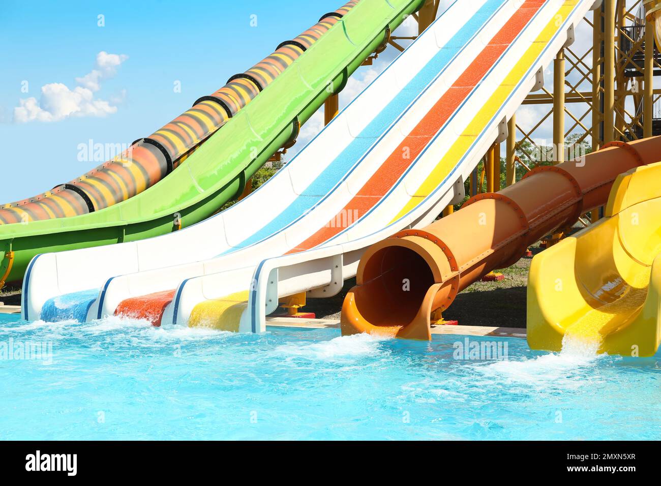 Different colorful slides in water park on sunny day Stock Photo - Alamy