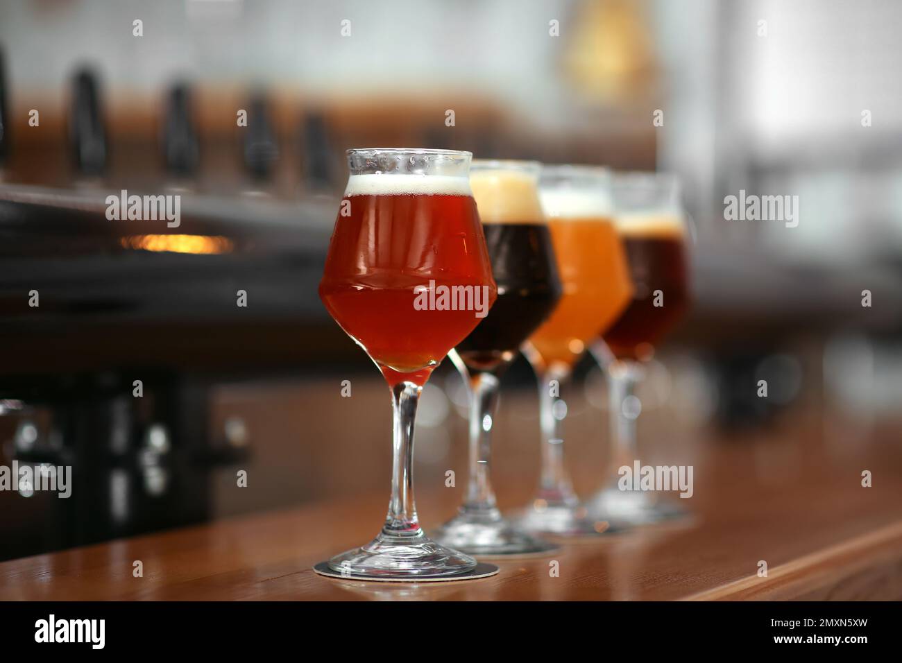 Different beers in glasses on bar counter Stock Photo - Alamy