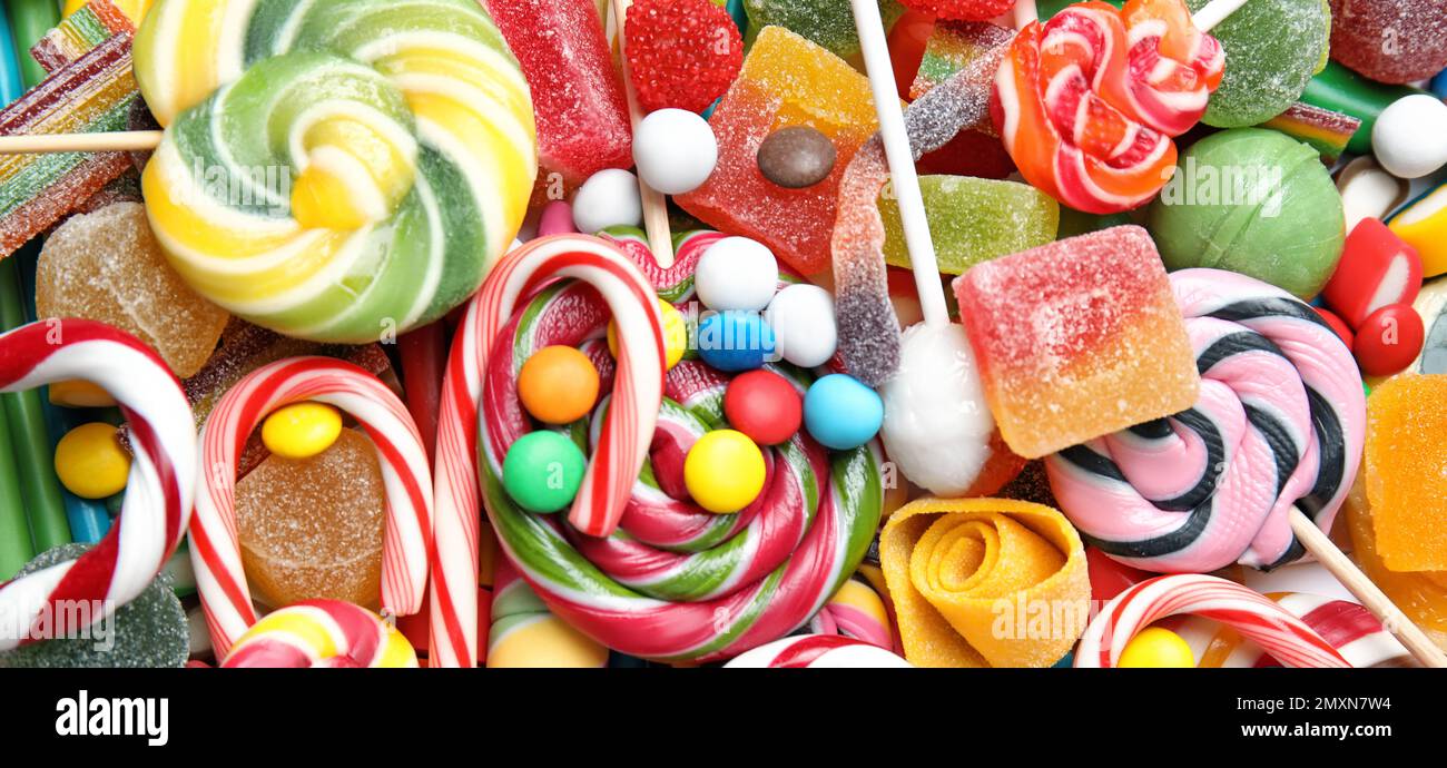Many different yummy candies as background, top view. Banner design ...