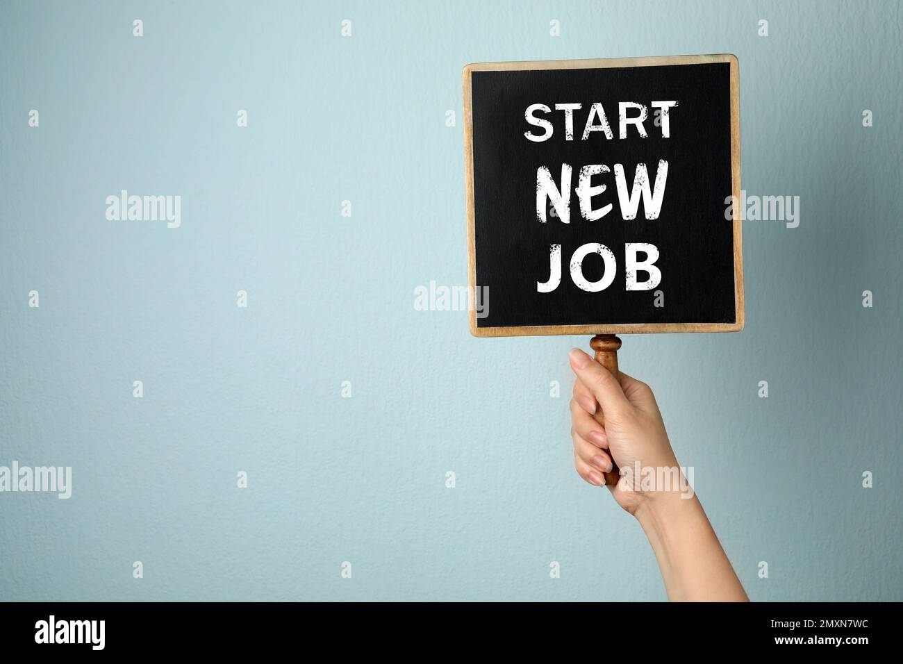 Change your life. Woman holding blackboard with text Start New Job on ...