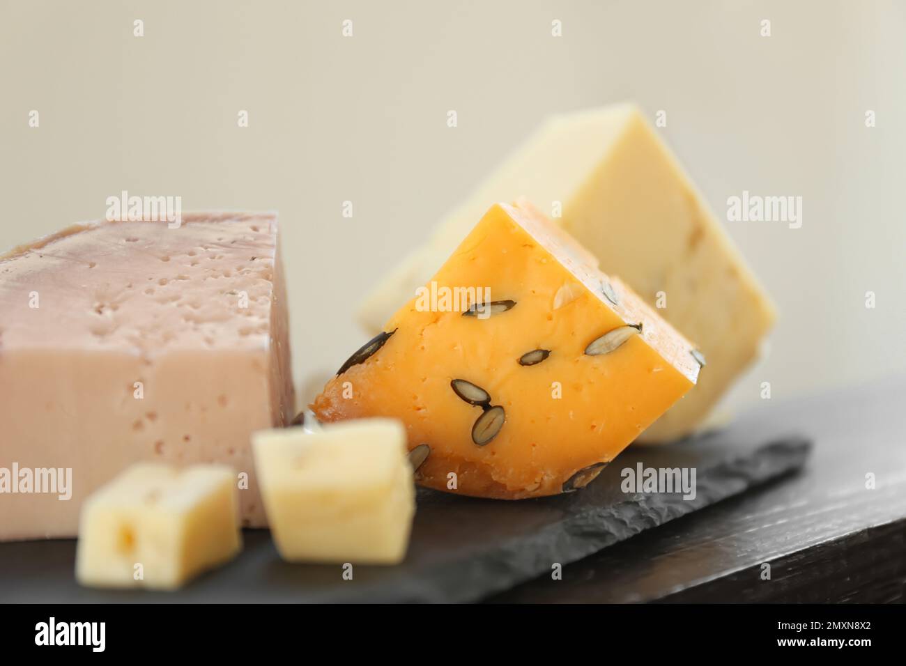 Different types of delicious cheeses on slate plate, closeup Stock ...