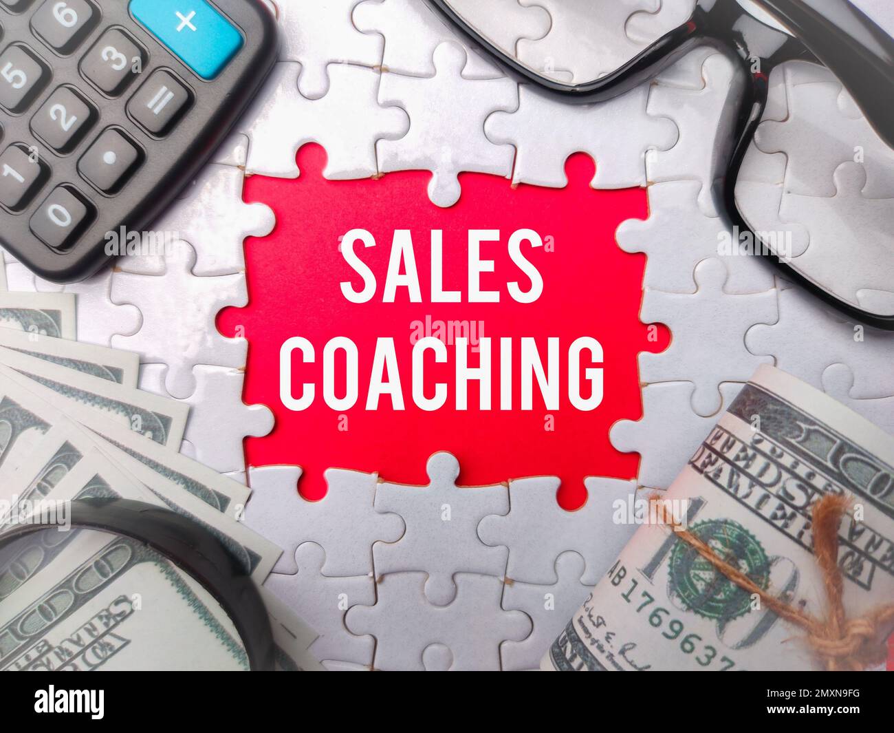 White puzzle with the word SALES COACHING on a red background. Business ...