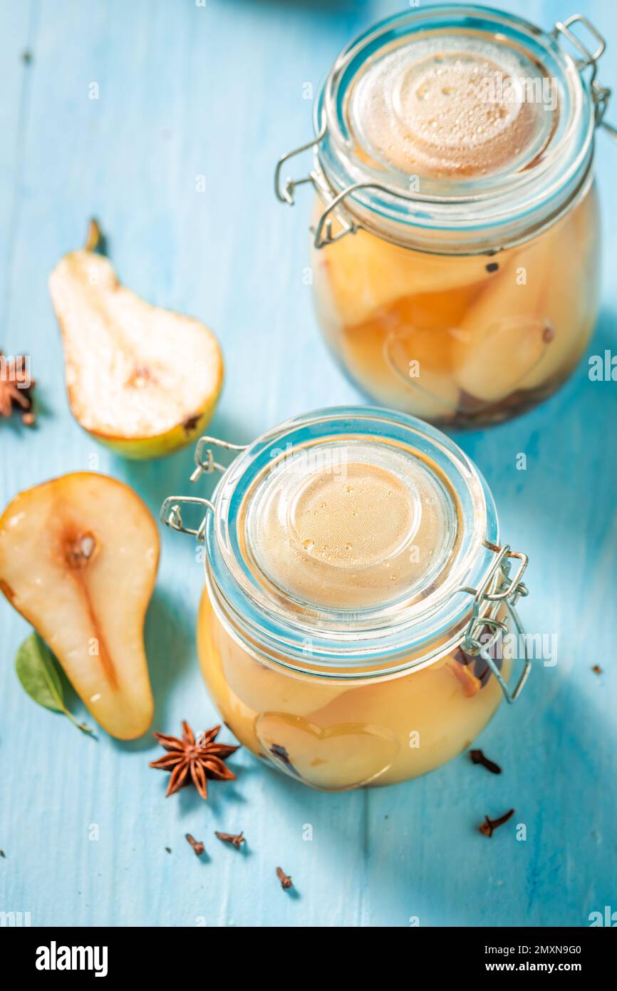 Homemade pickled pears in vinegar with cloves. Seasonal fruits pickled ...