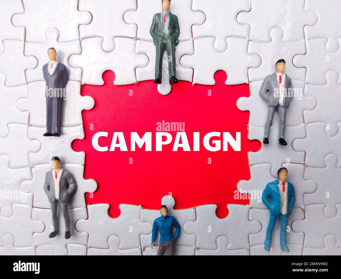 White puzzle with the word CAMPAIGN on a red background Stock Photo - Alamy