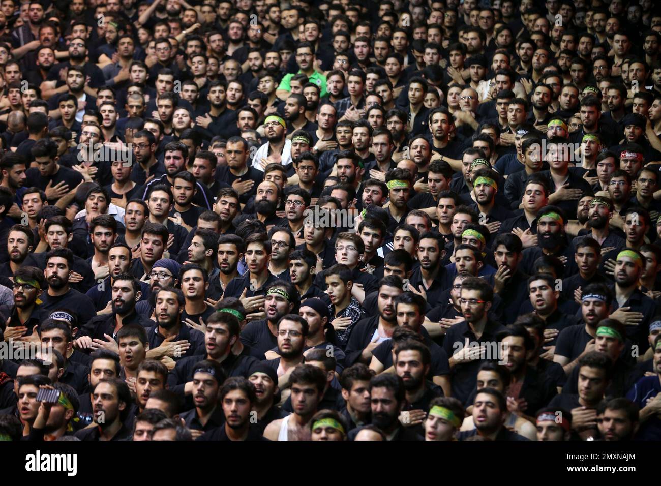 Iranian Shiite Muslims take part in a mourning ceremony during the ...