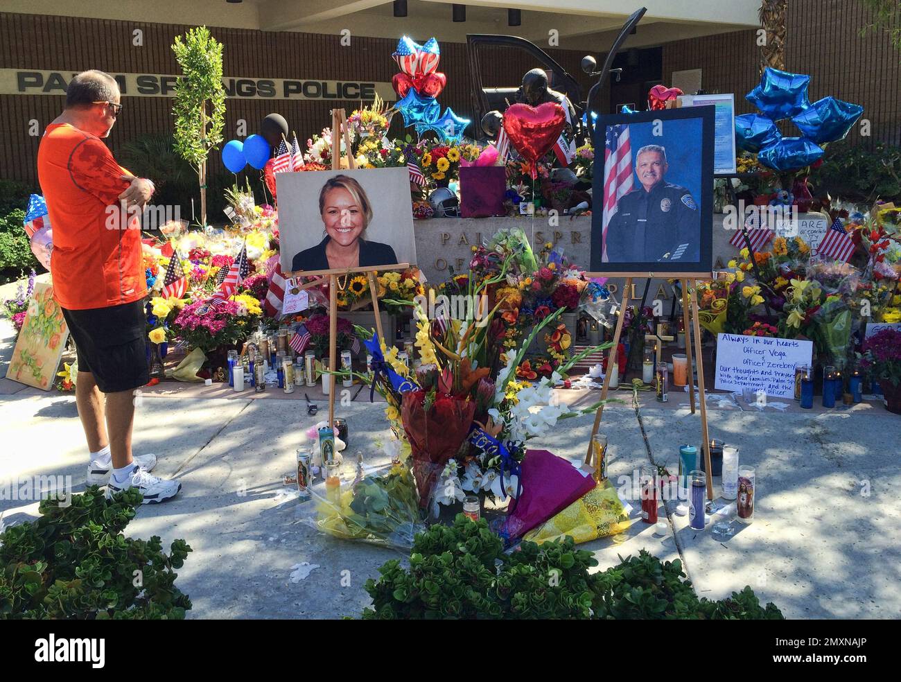 A visitor pays his respect at a memorial for Palm Springs Police ...