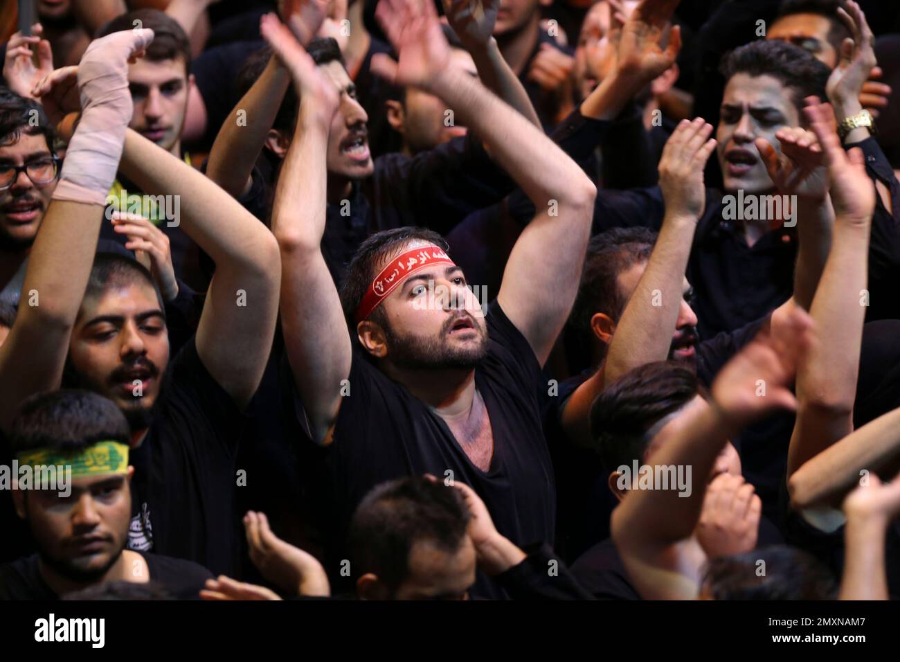 Iranian Shiite Muslims take part in a mourning ceremony during the ...