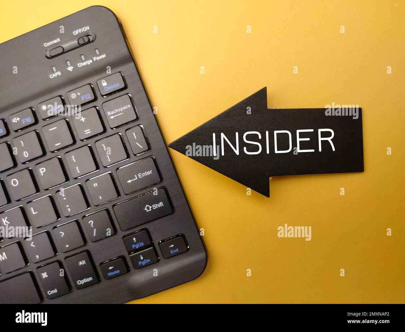 Wireless keyboard and arrow wooden board with the word INSIDER on ...
