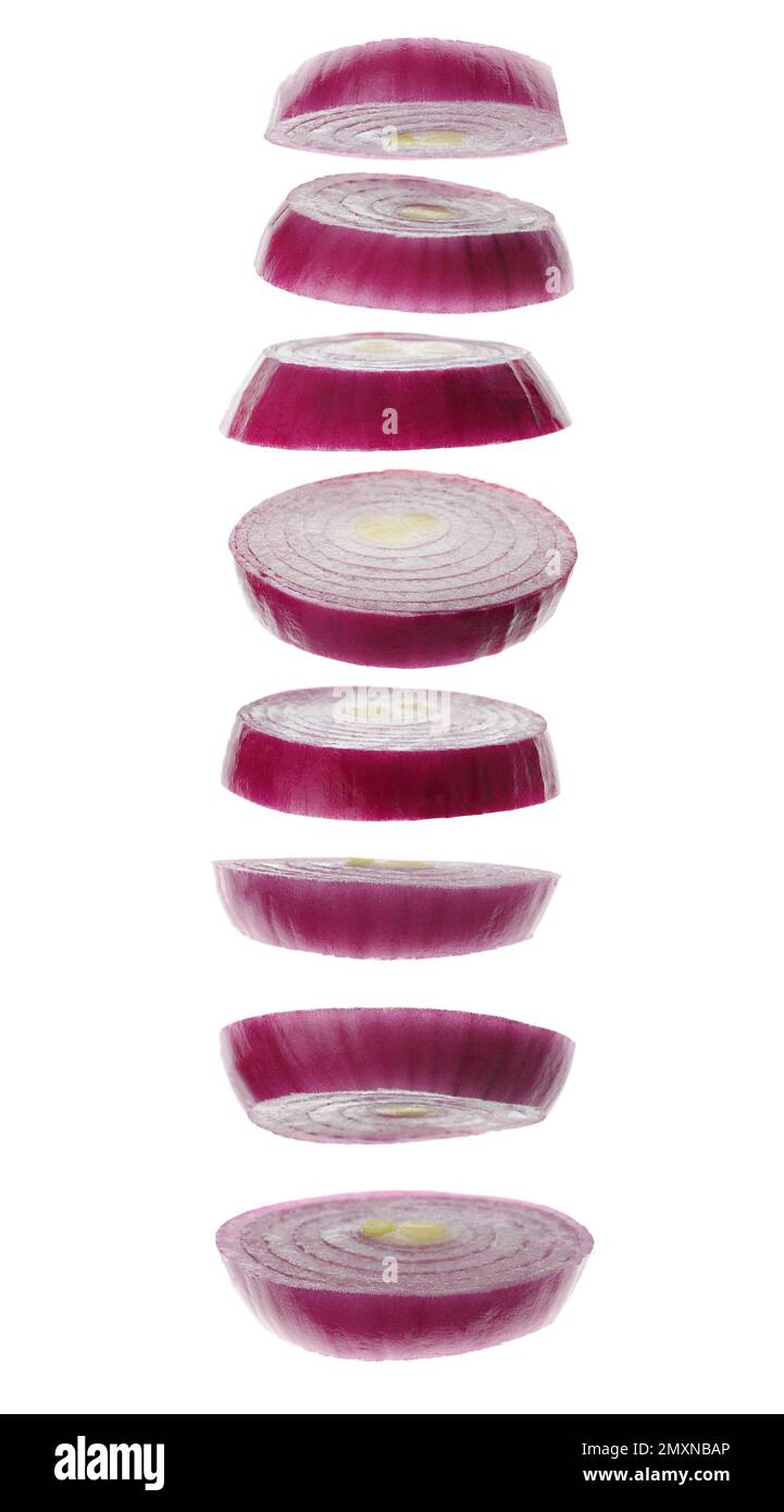 Red onion slices falling on white background Stock Photo - Alamy