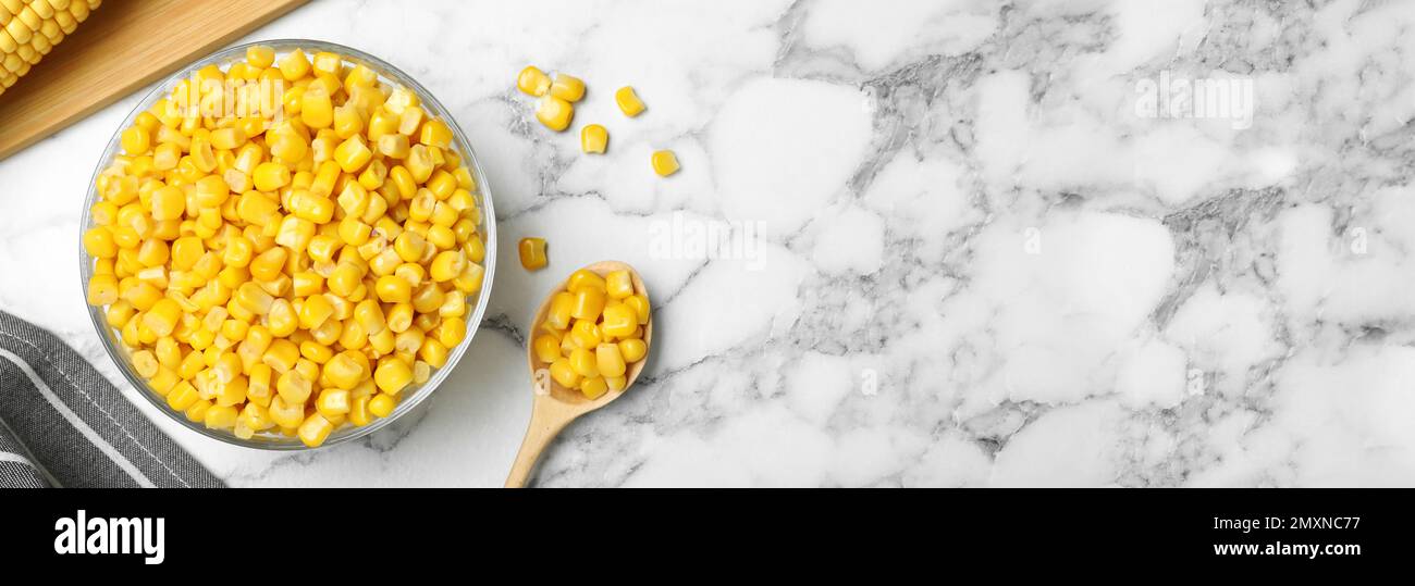 Delicious canned corn in bowl and space for text on marble table, flat ...