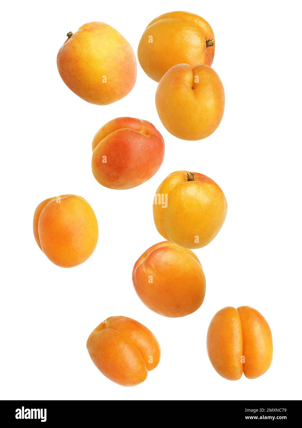 Whole ripe apricots falling on white background Stock Photo - Alamy