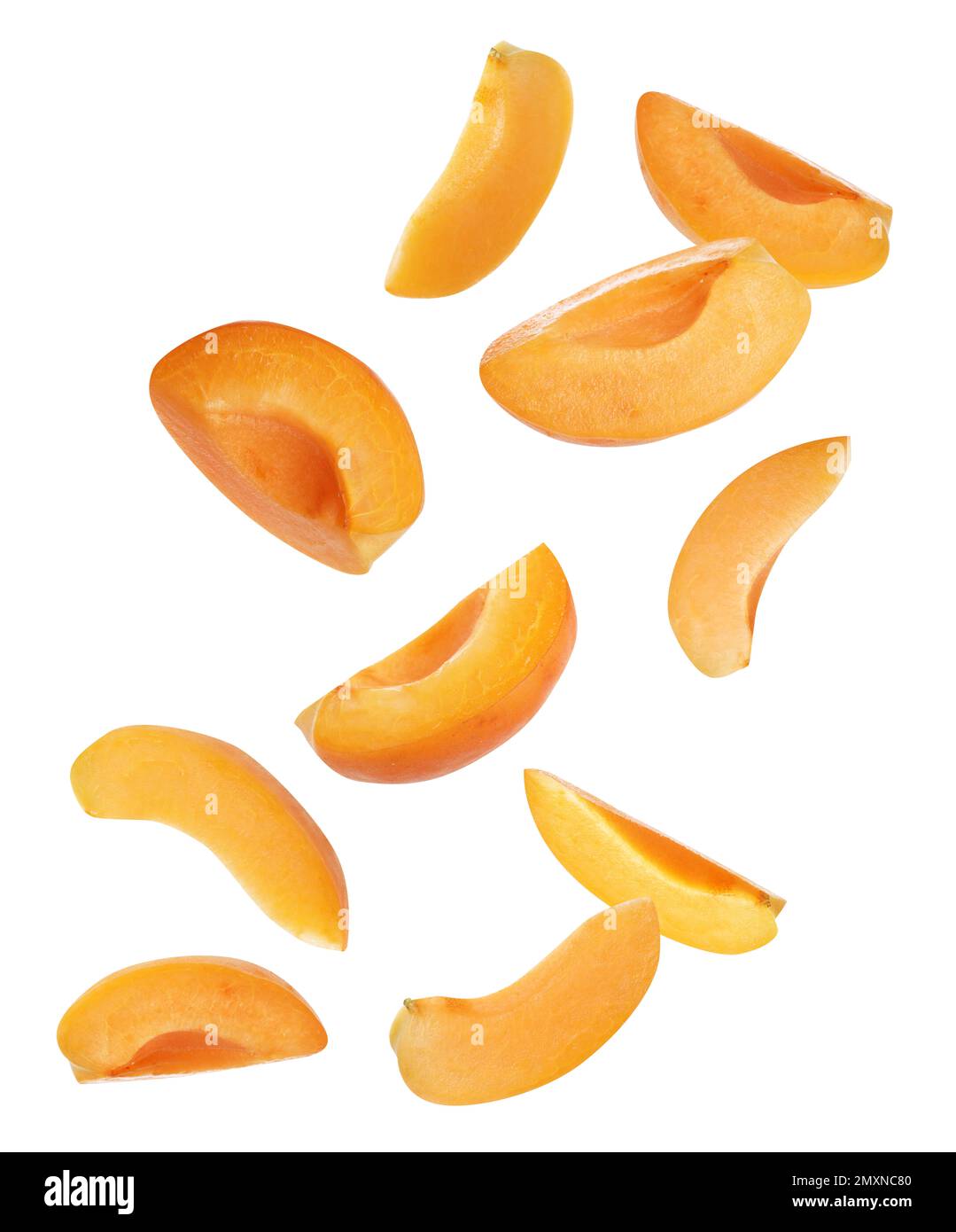 Ripe apricot slices falling on white background Stock Photo - Alamy