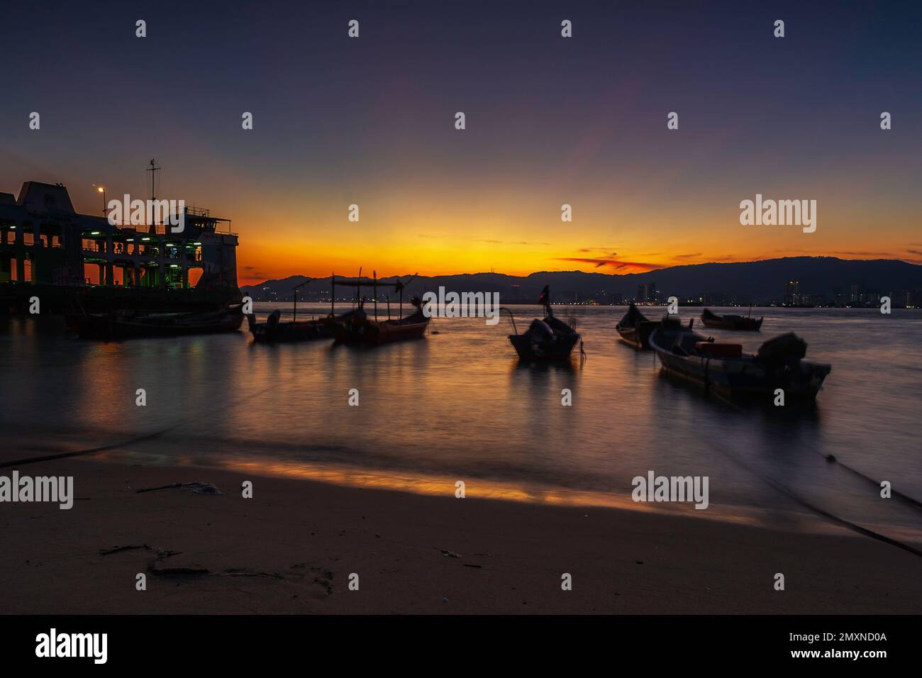 Beautiful sunset view at penang jetty with fisherman boats at Penang ...