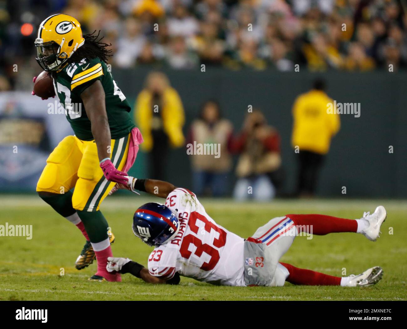 Green Bay Packers' Eddie Lacy runs past New York Giants' Andrew Adams ...
