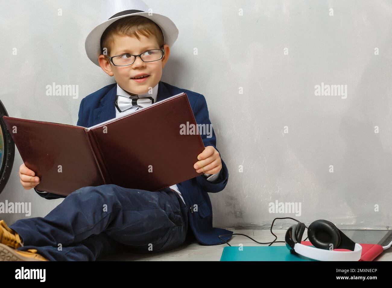 Happy curious kid little boy genius on gray background Stock Photo - Alamy