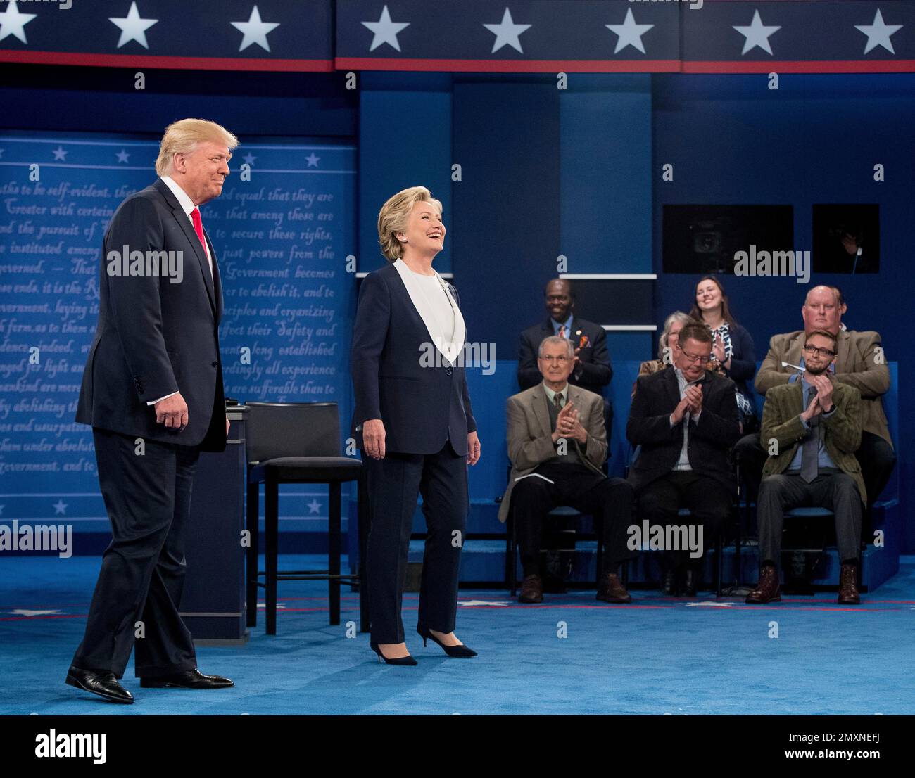 Democratic presidential candidate Hillary Clinton stands next to ...