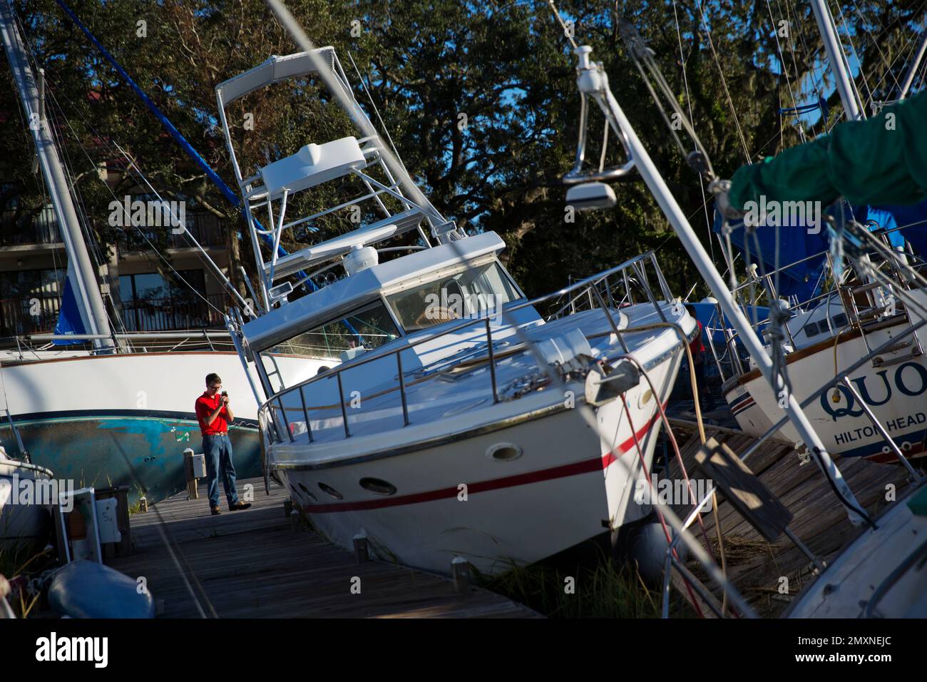 Boats sit pushed up amongst the twisted docks at Palmetto Bay Marina ...