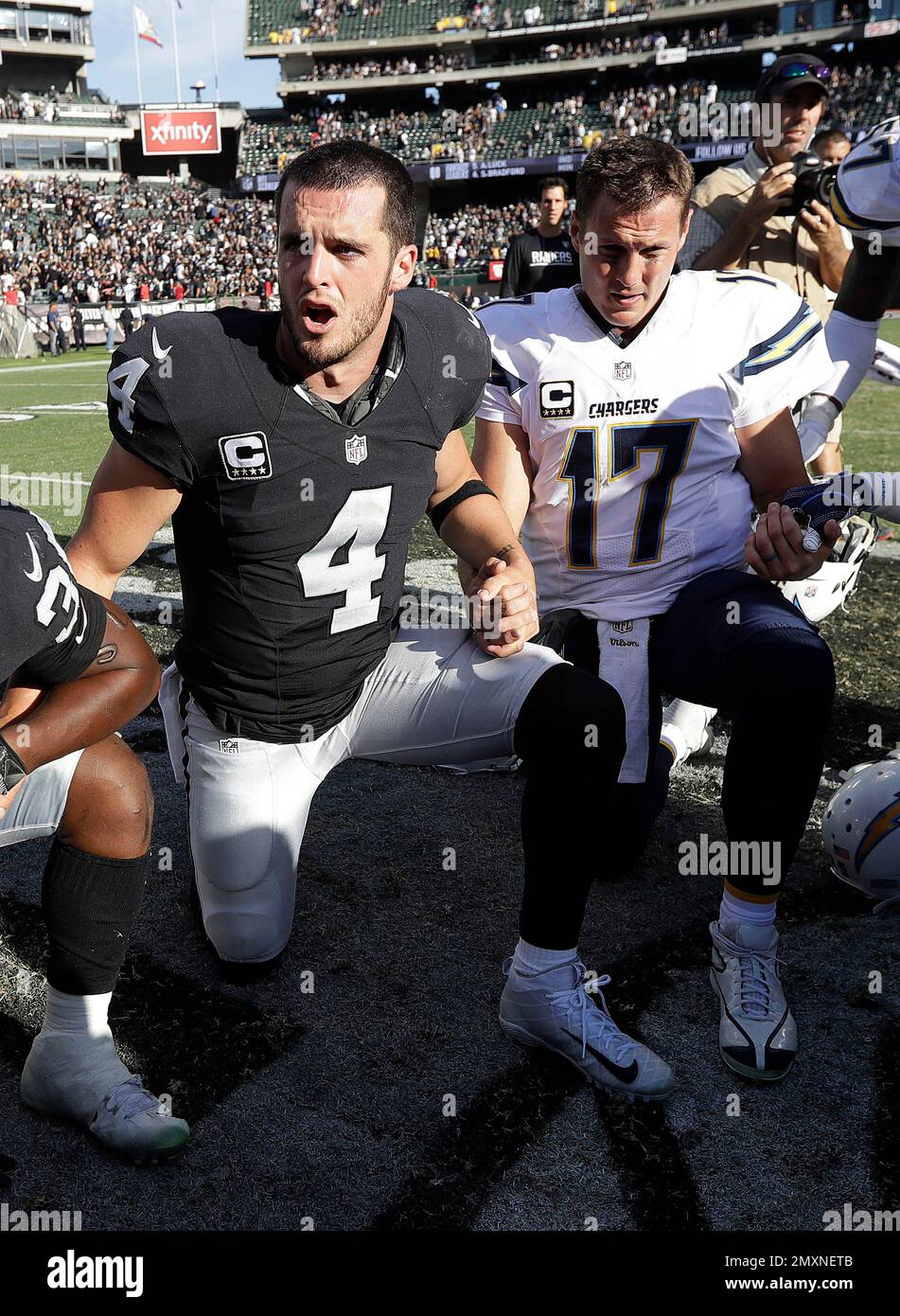 Oakland Raiders quarterback Derek Carr (4) and San Diego Chargers ...