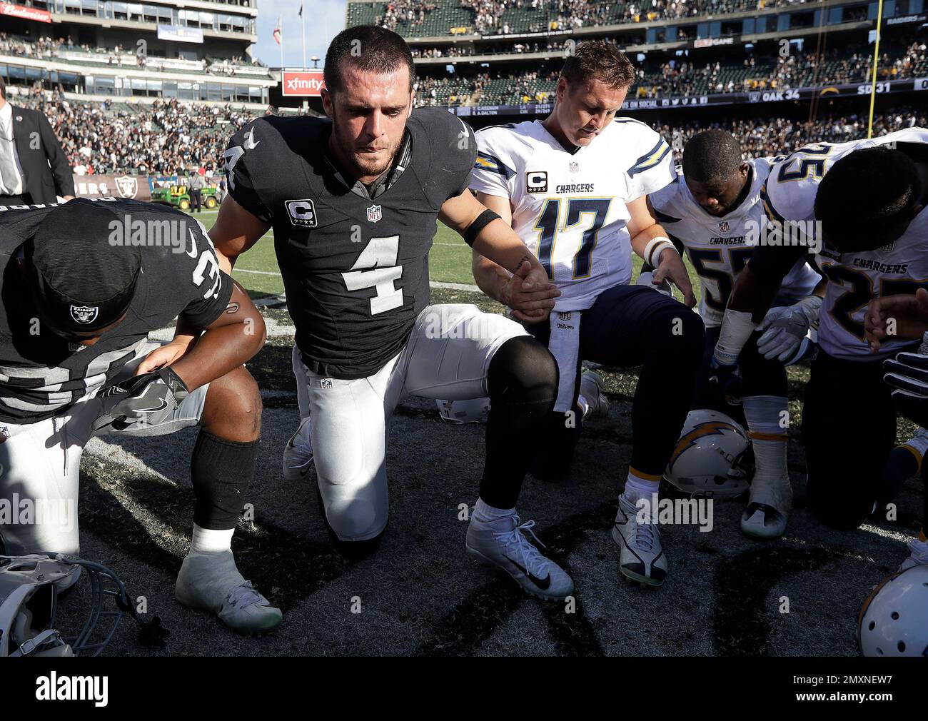 Oakland Raiders quarterback Derek Carr (4) and San Diego Chargers ...