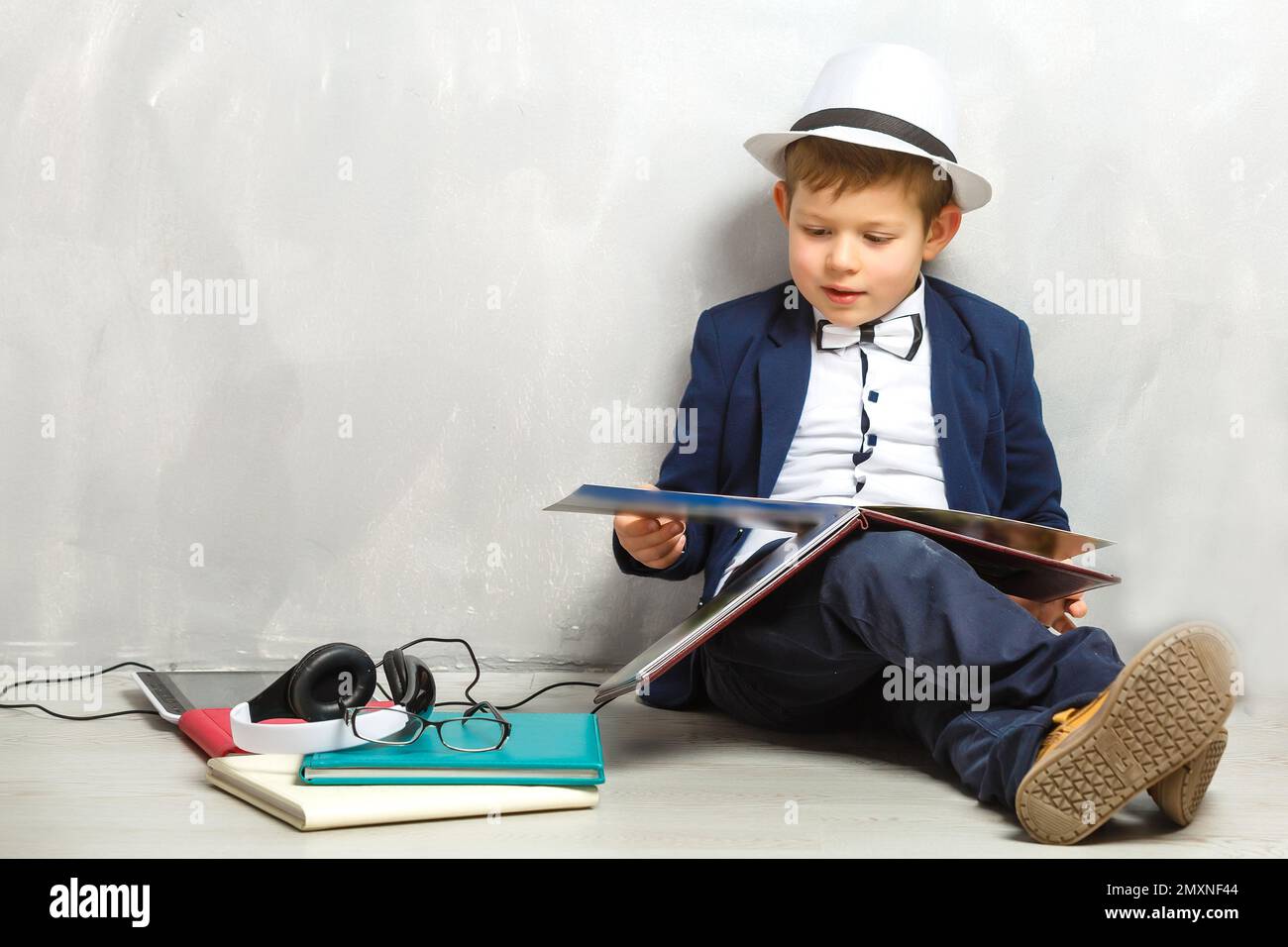 Happy curious kid little boy genius on gray background Stock Photo - Alamy