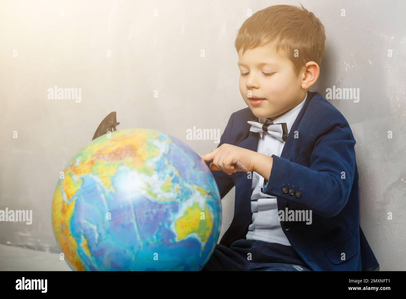 Happy curious kid little boy genius on gray background Stock Photo - Alamy