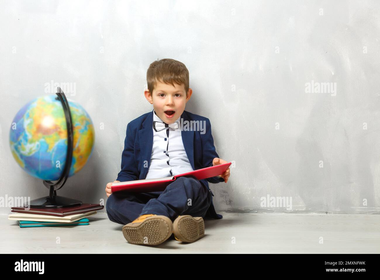 Happy curious kid little boy genius on gray background Stock Photo - Alamy