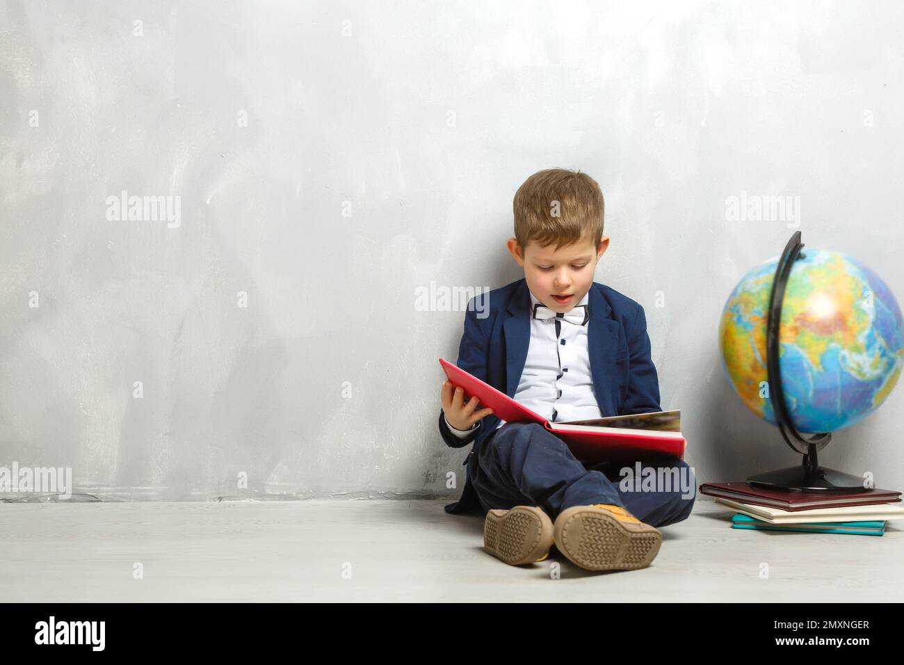 Happy curious kid little boy genius on gray background Stock Photo - Alamy