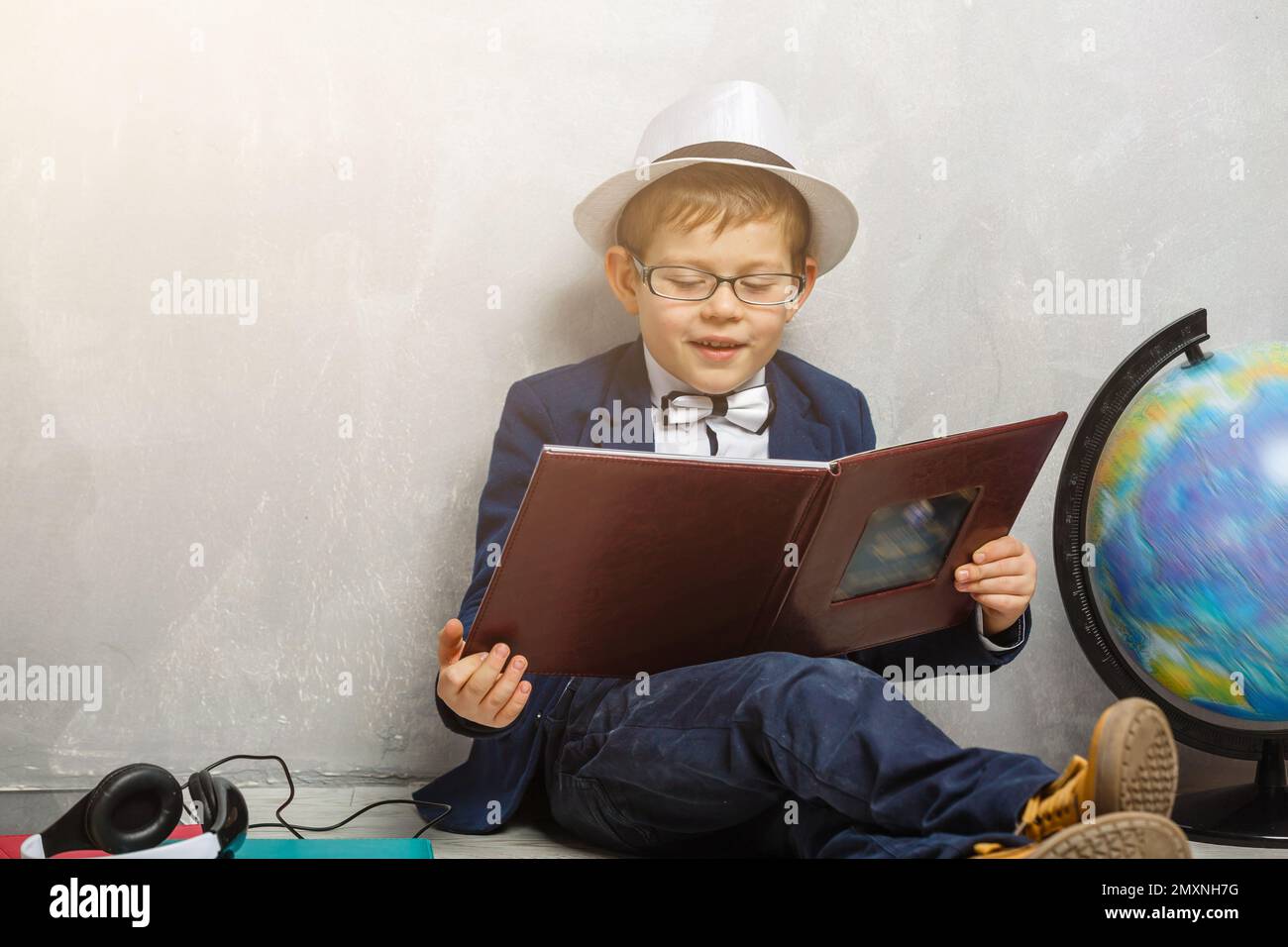 Happy curious kid little boy genius on gray background Stock Photo - Alamy