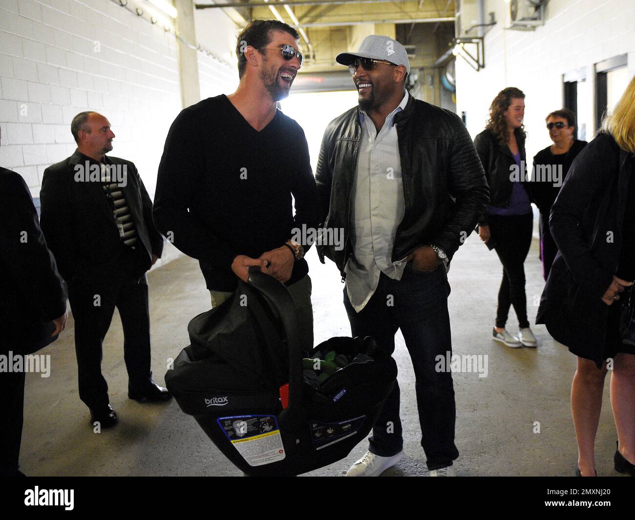 Olympic swimmer Michael Phelps, left, talks with former Baltimore ...