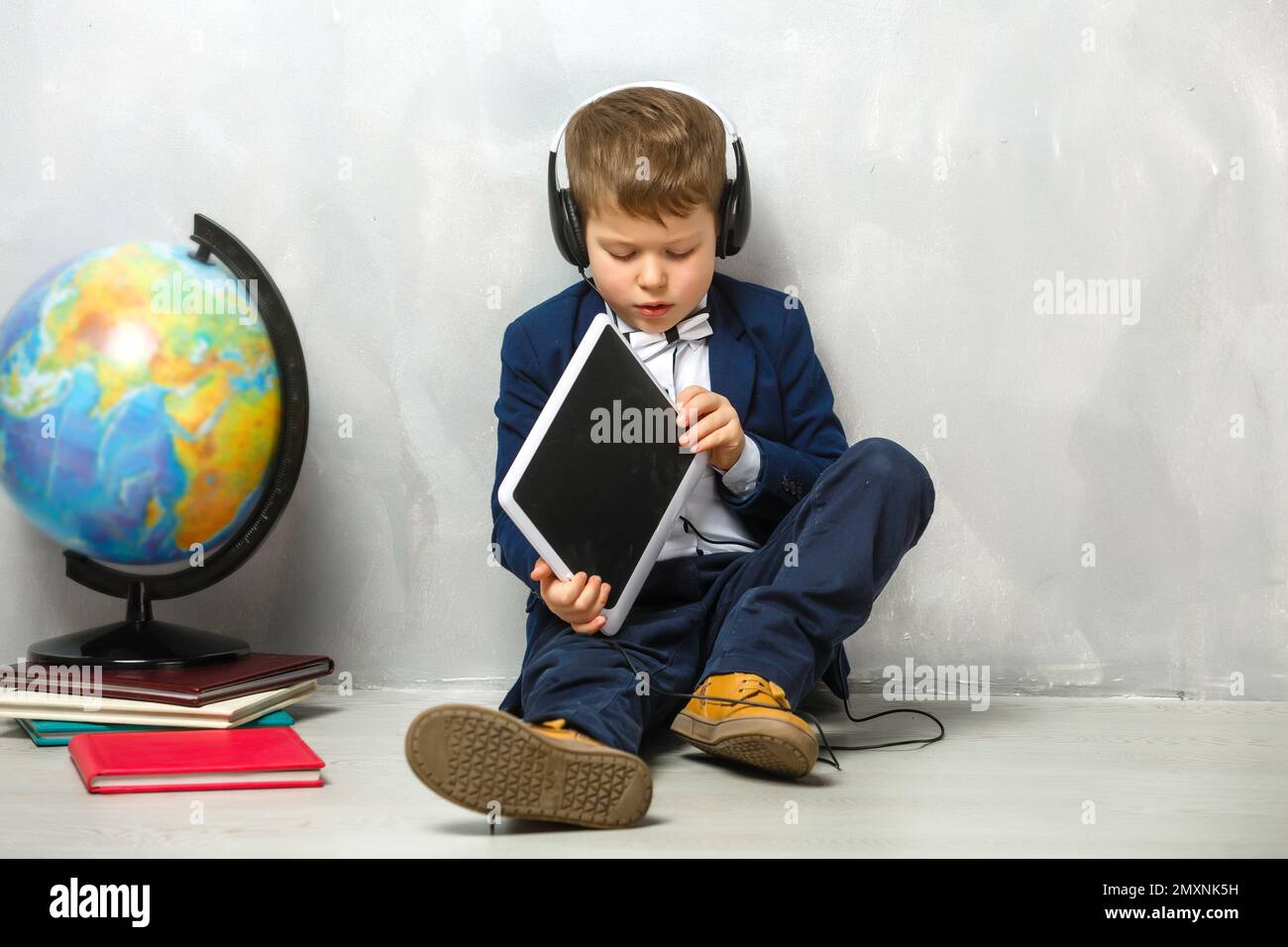 Happy curious kid little boy genius on gray background Stock Photo - Alamy