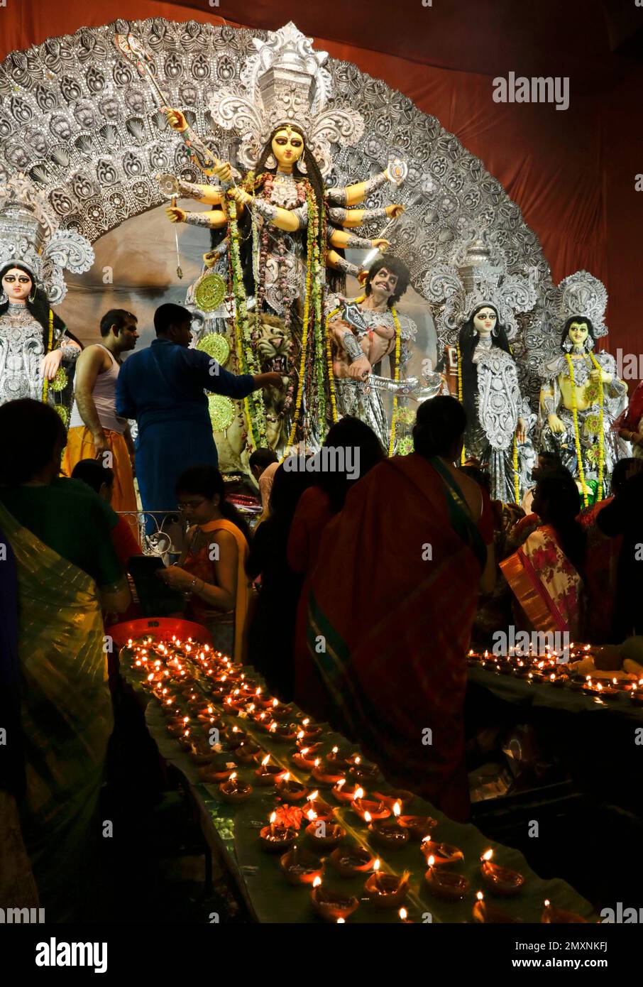 Devotees throng a makeshift worship place of Hindu goddess Durga during ...