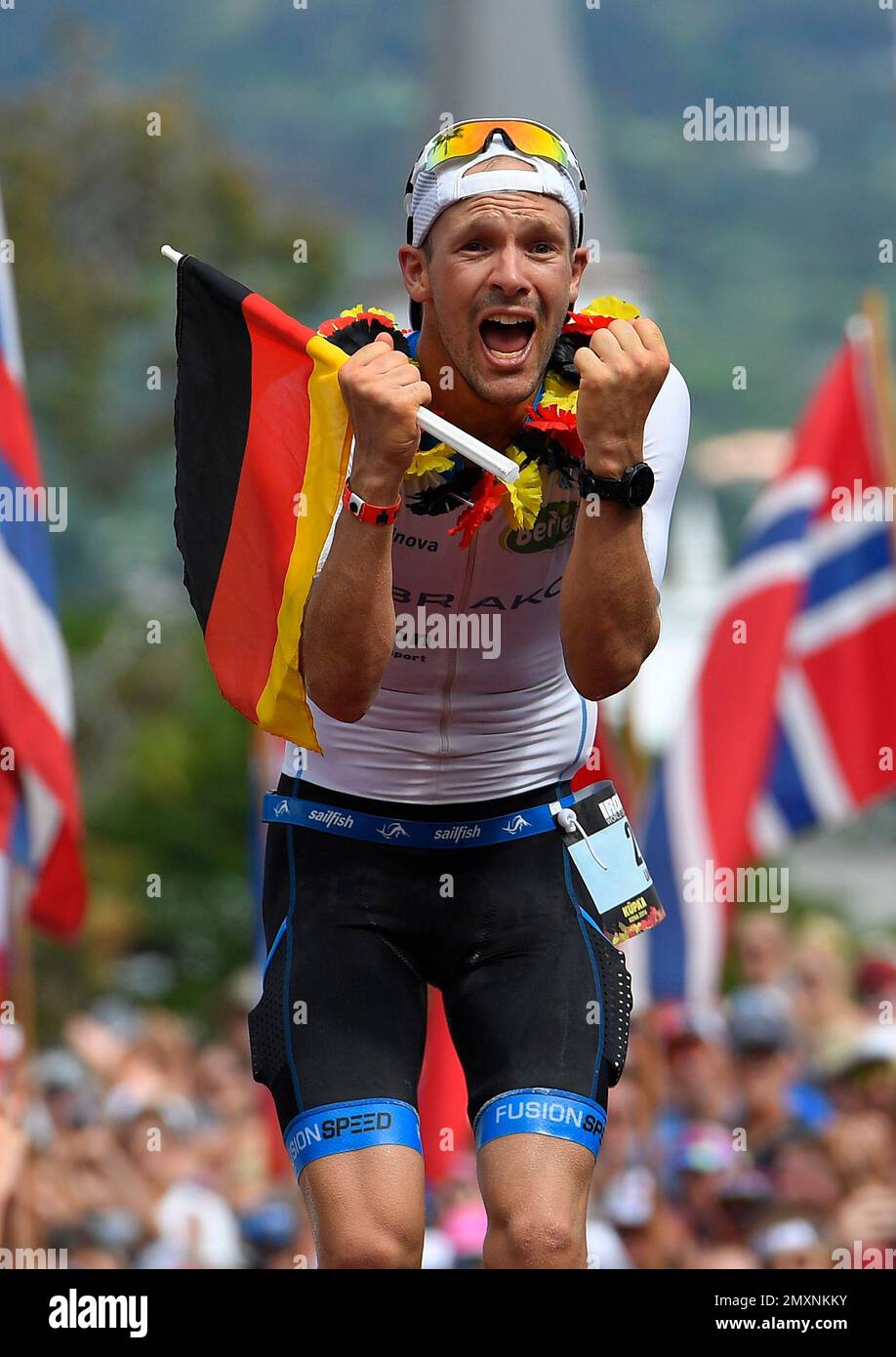 Patrick Lange, of Germany, celebrates as he takes third in the Ironman ...