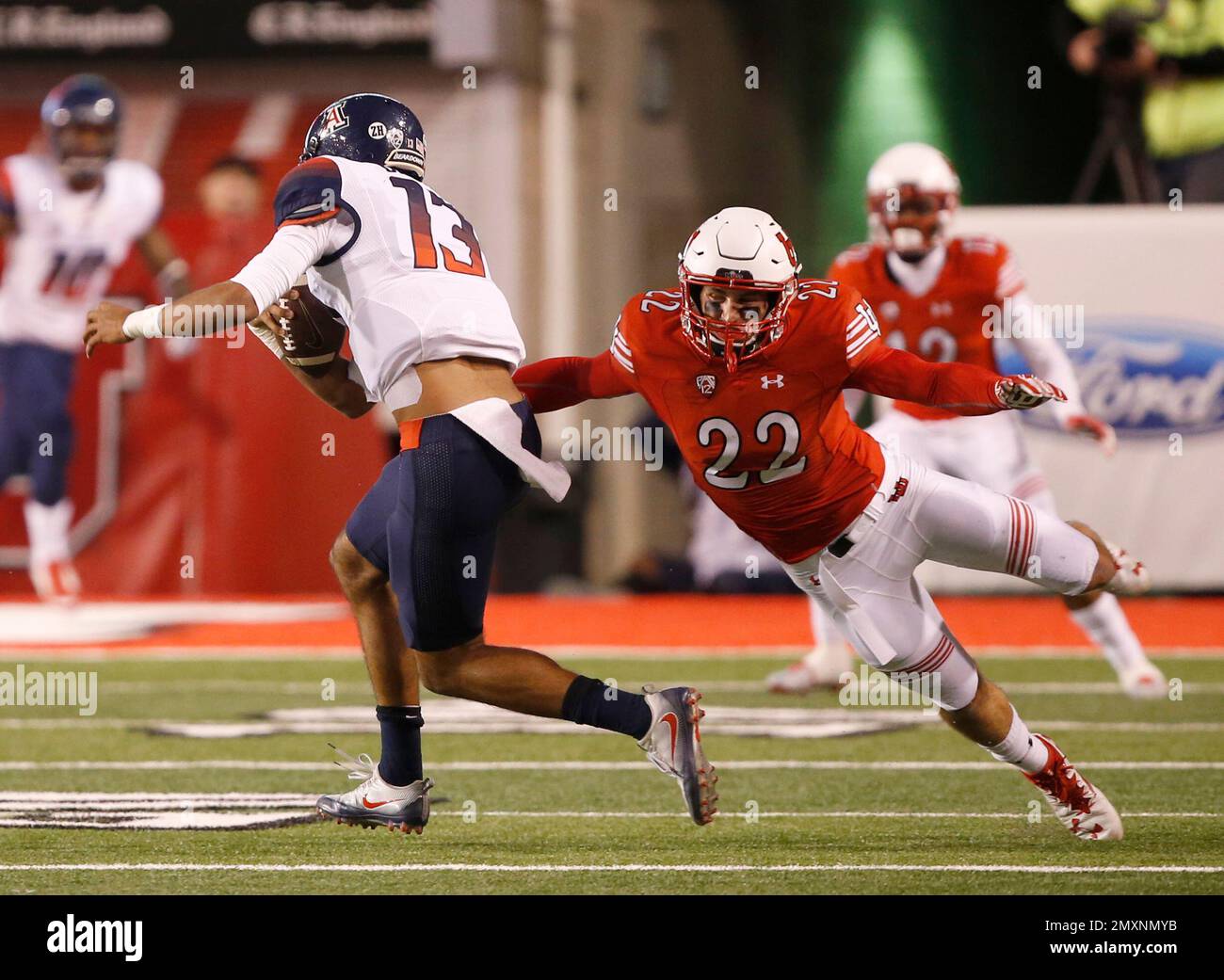 Arizona quarterback Brandon Dawkins (13) runs out of the tackle of Utah ...