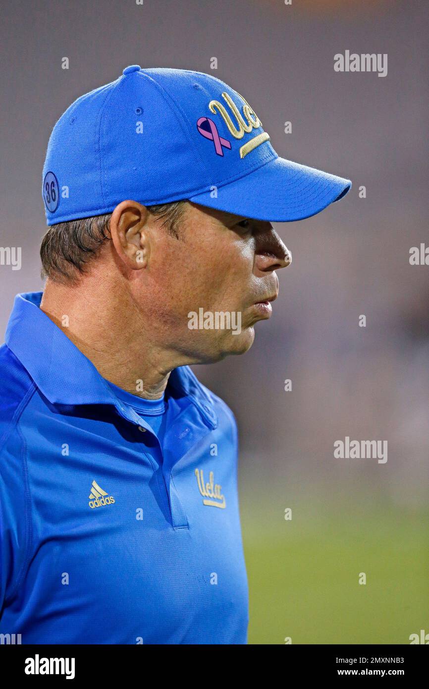 UCLA head coach Jim Mora watches his players warm up prior to an NCAA ...