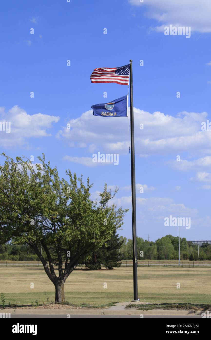 US Flags flying on a flag pole with blue sky Stock Photo - Alamy