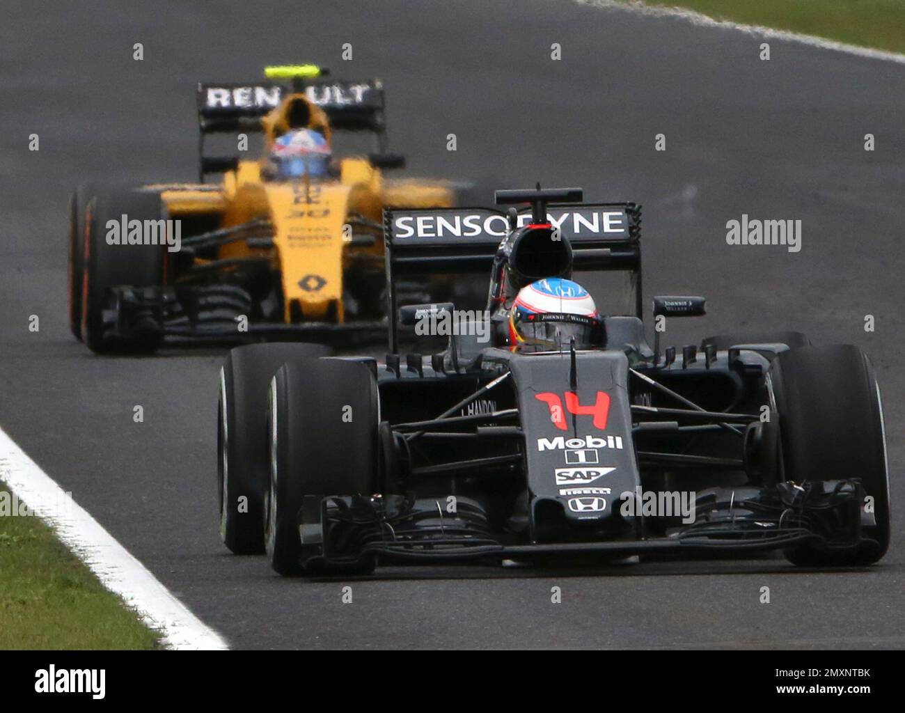 McLaren driver Fernando Alonso of Spain steers his car, followed by Renault driver Jolyon Palmer ...