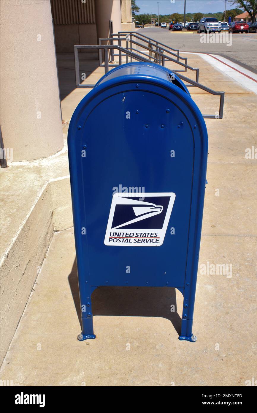 A US Mail box shot closeup on a sidewalk Stock Photo - Alamy