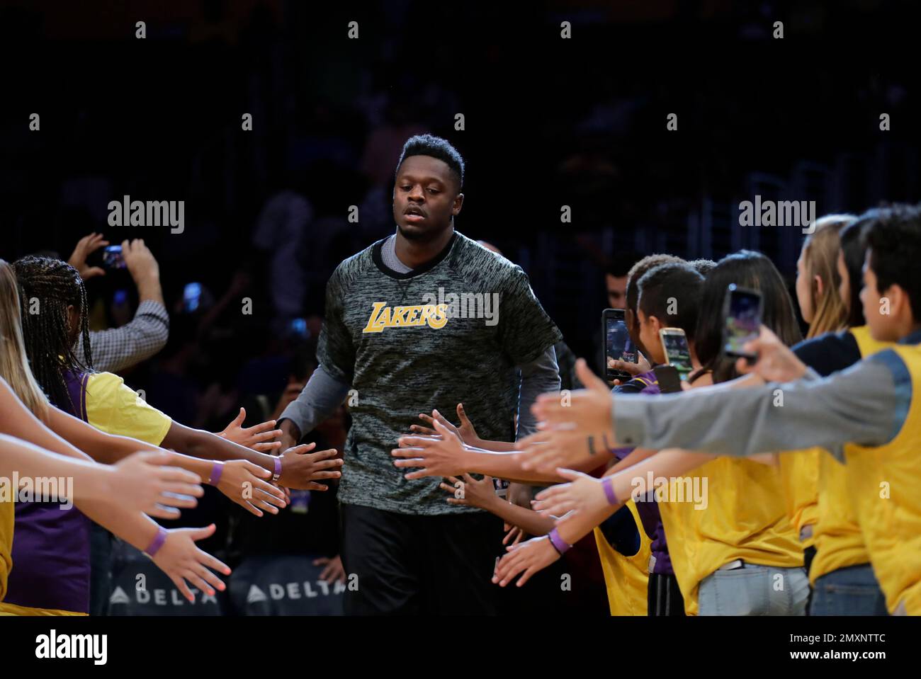 Los Angeles Lakers' Julius Randle is greeted by young children before ...